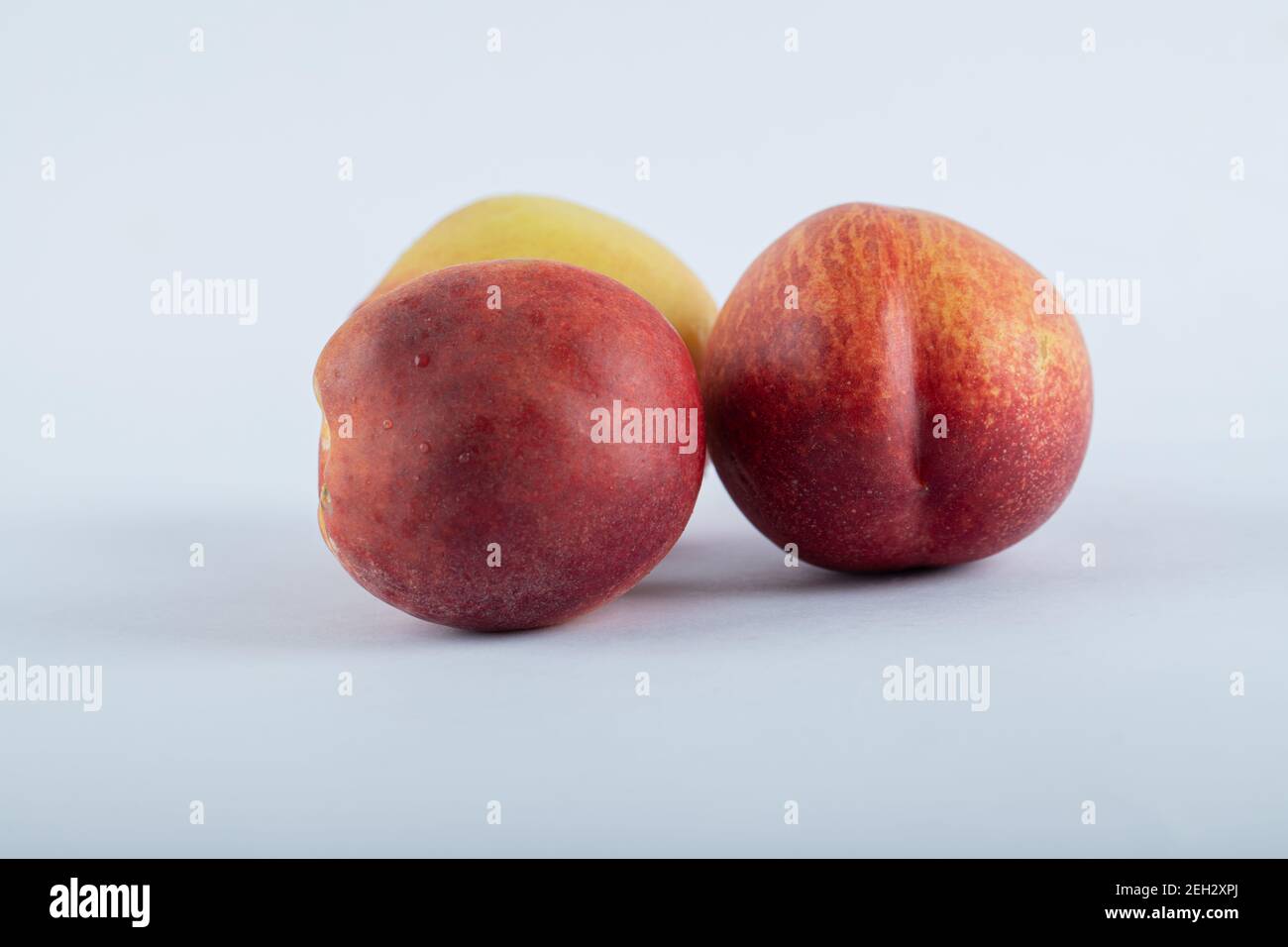Three fresh nectarines located on white background Stock Photo - Alamy
