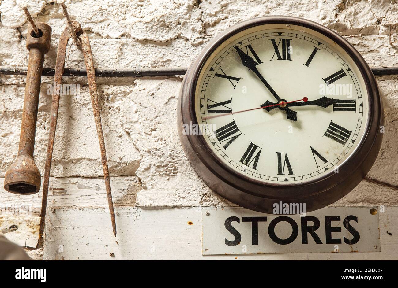 Clock on workshop wall Stock Photo - Alamy
