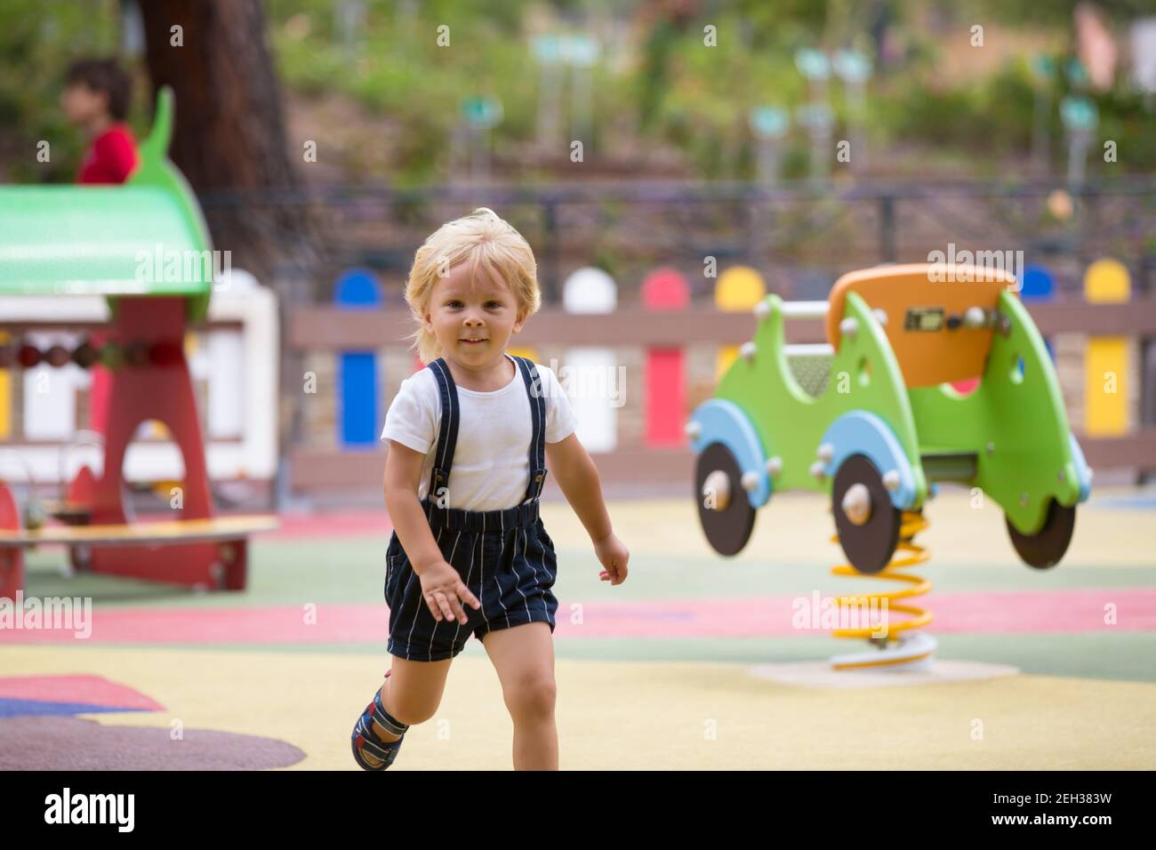 Sweet toddler child, boy, playing on the playground summertime Stock ...