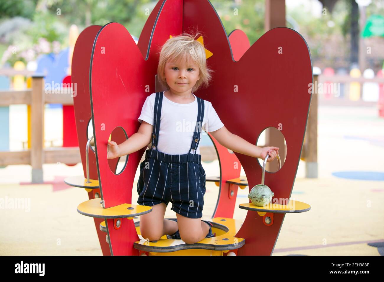 Sweet toddler child, boy, playing on the playground summertime Stock ...