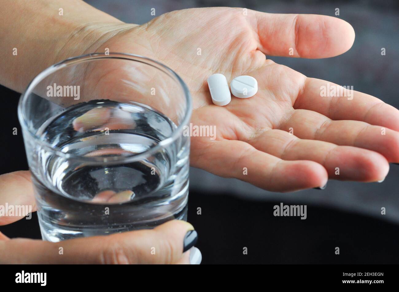 Female hands with tablets and glass of water. Concept of Taking Your ...