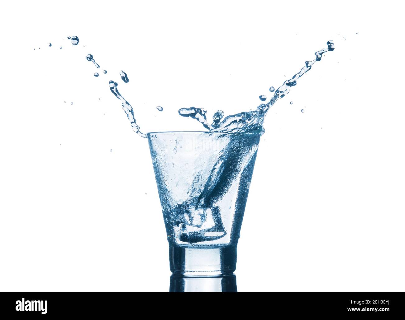 Water splash in glasses isolated on white background. Cold mineral ...