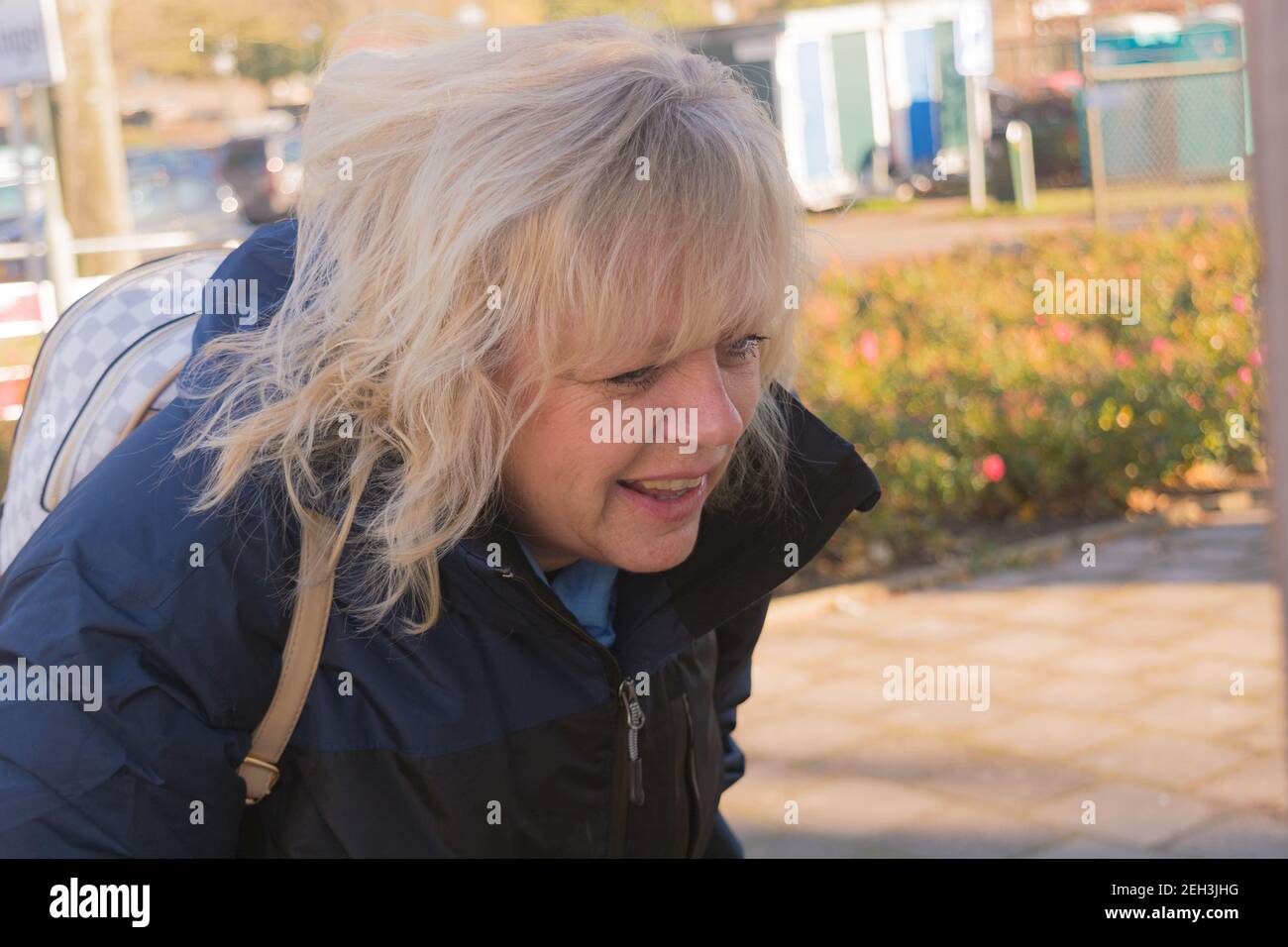 Attractive tourist stands in front of a map during a hiking tour Stock ...