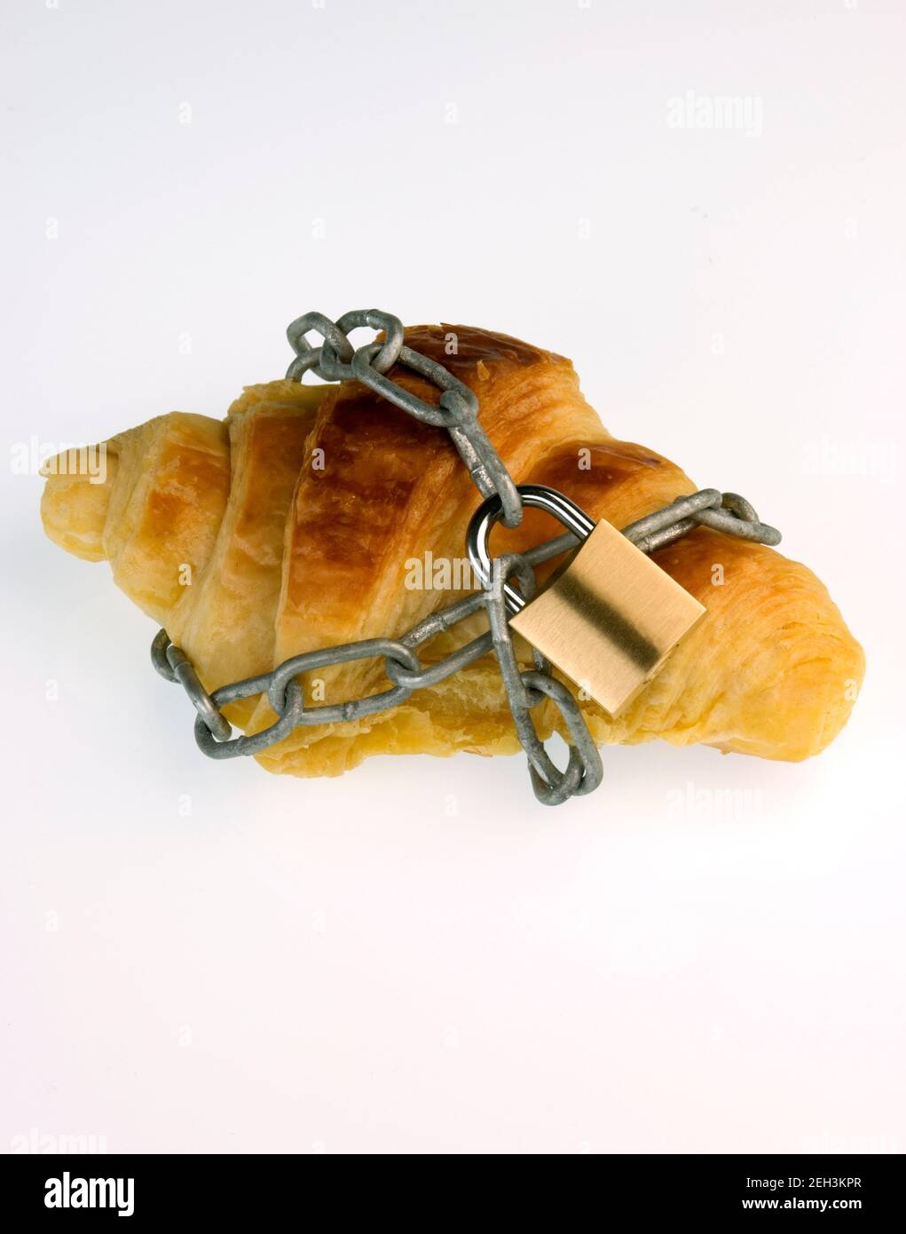Croissant pastry wrapped in chain and padlock Stock Photo - Alamy