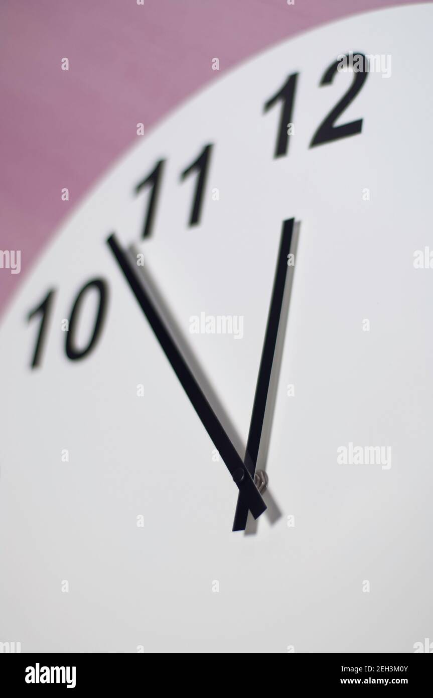 Clock face showing hands at 11:53 Stock Photo - Alamy