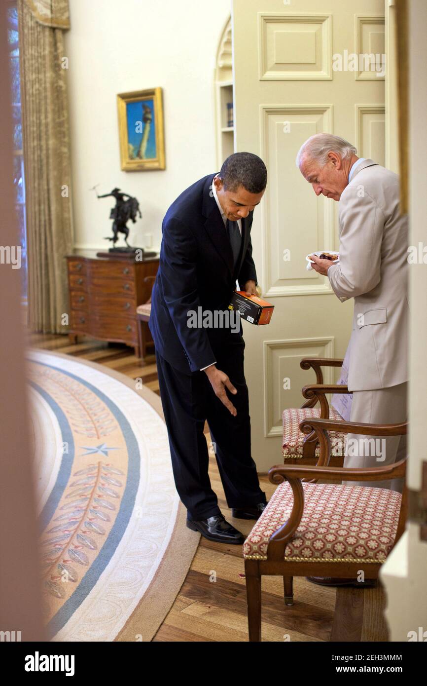 President Barack Obama points out cake crumbs on the floor to Vice ...