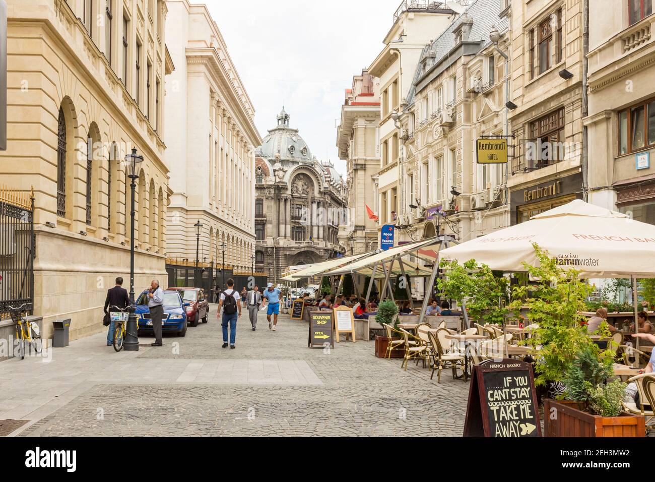 Outdoor dining and restaurants lining a street in central Bucharest ...
