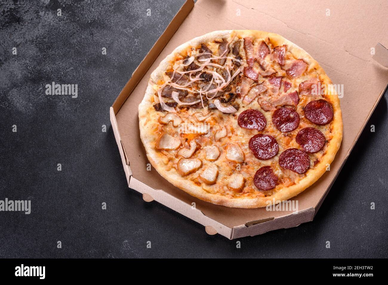 Fresh delicious pizza made in a hearth oven with four types of meat and ...