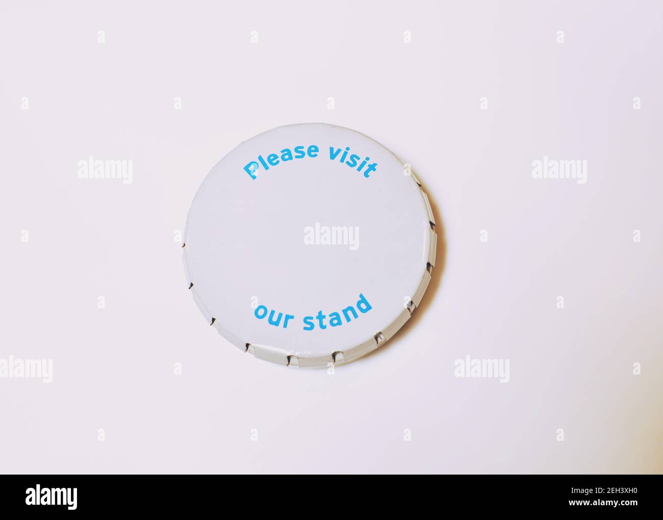 White little round box with inscription Please visit our stand and copy ...