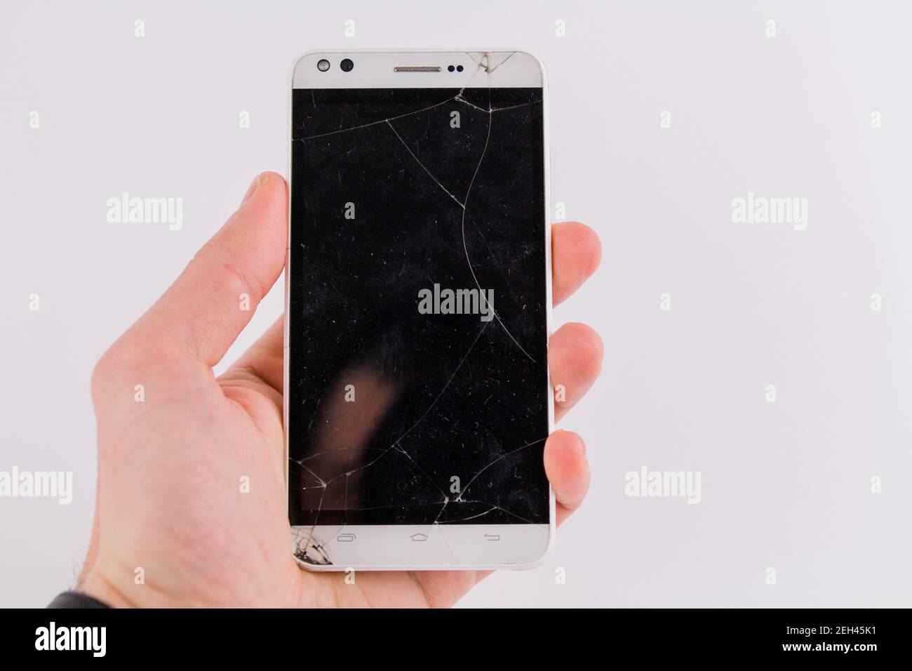 a smartphone with broken screen in hand on white background Stock Photo ...