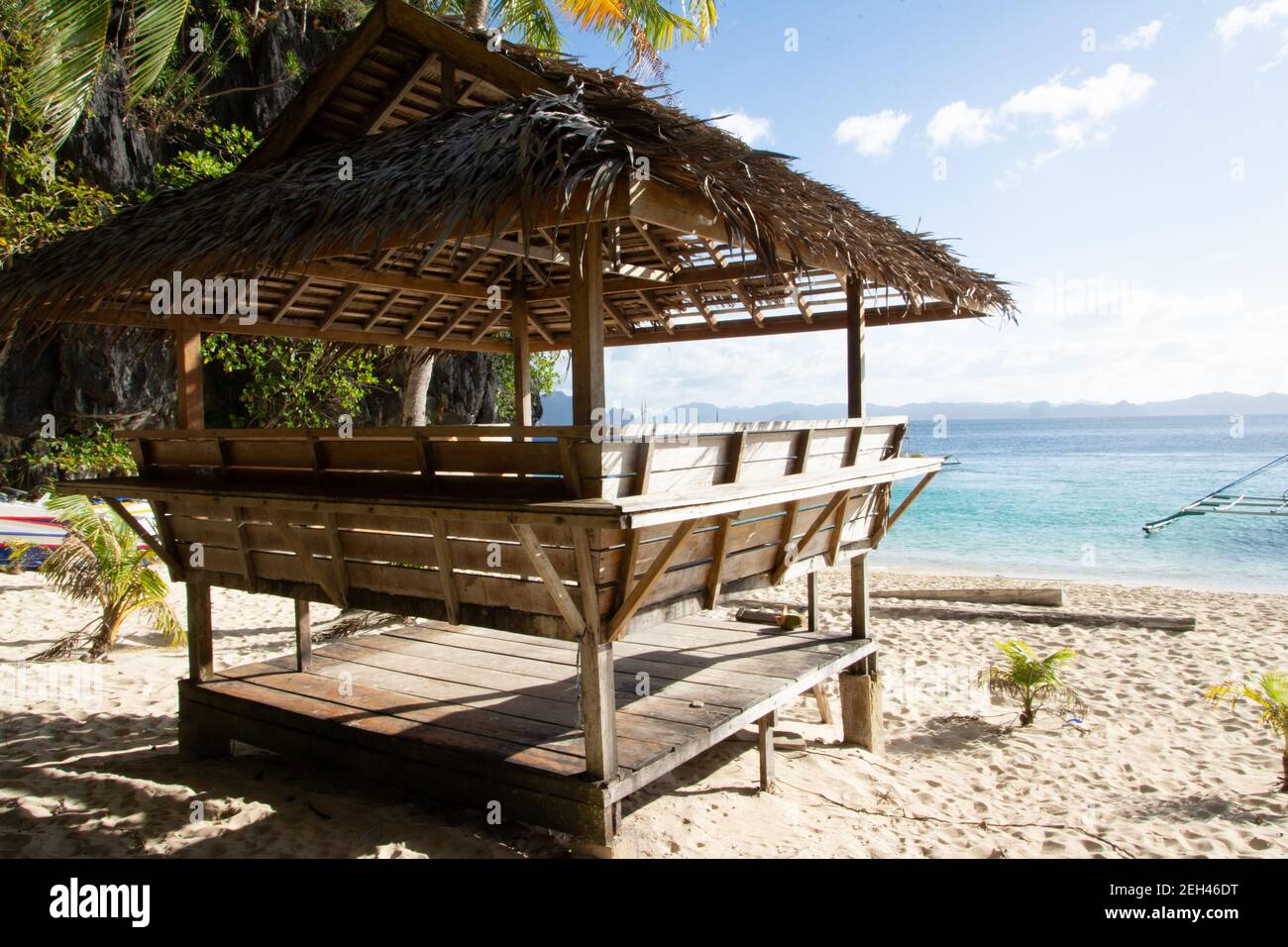 Small wooden pavilion at a white sand beach in an island in the ...