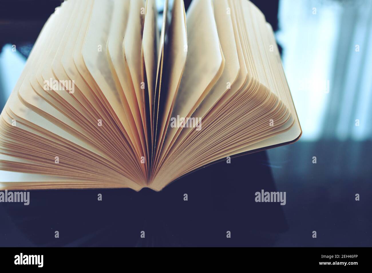 Open book on black background. Side view Stock Photo - Alamy