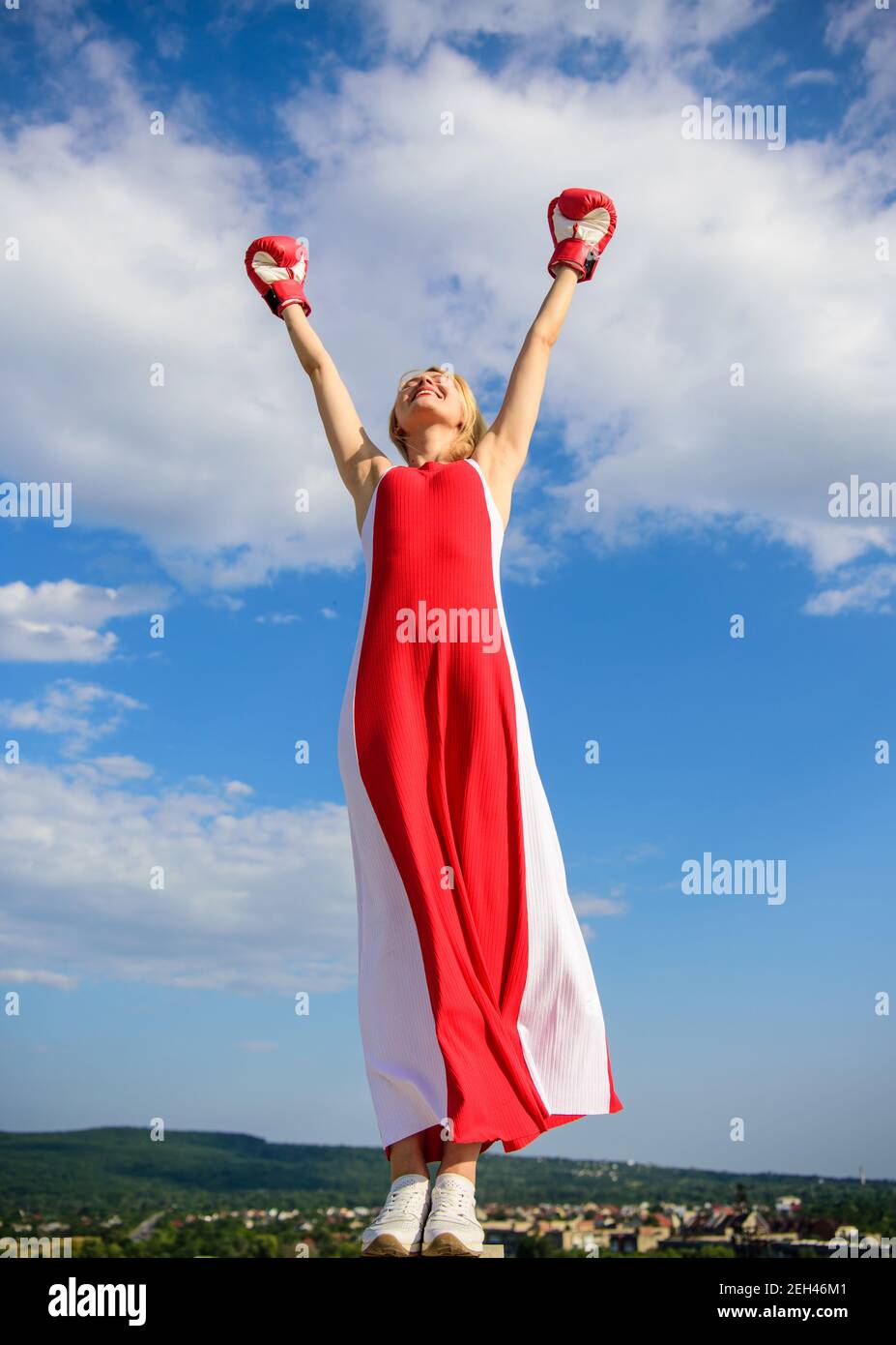Femininity and strength balance. Woman red dress and boxing gloves ...