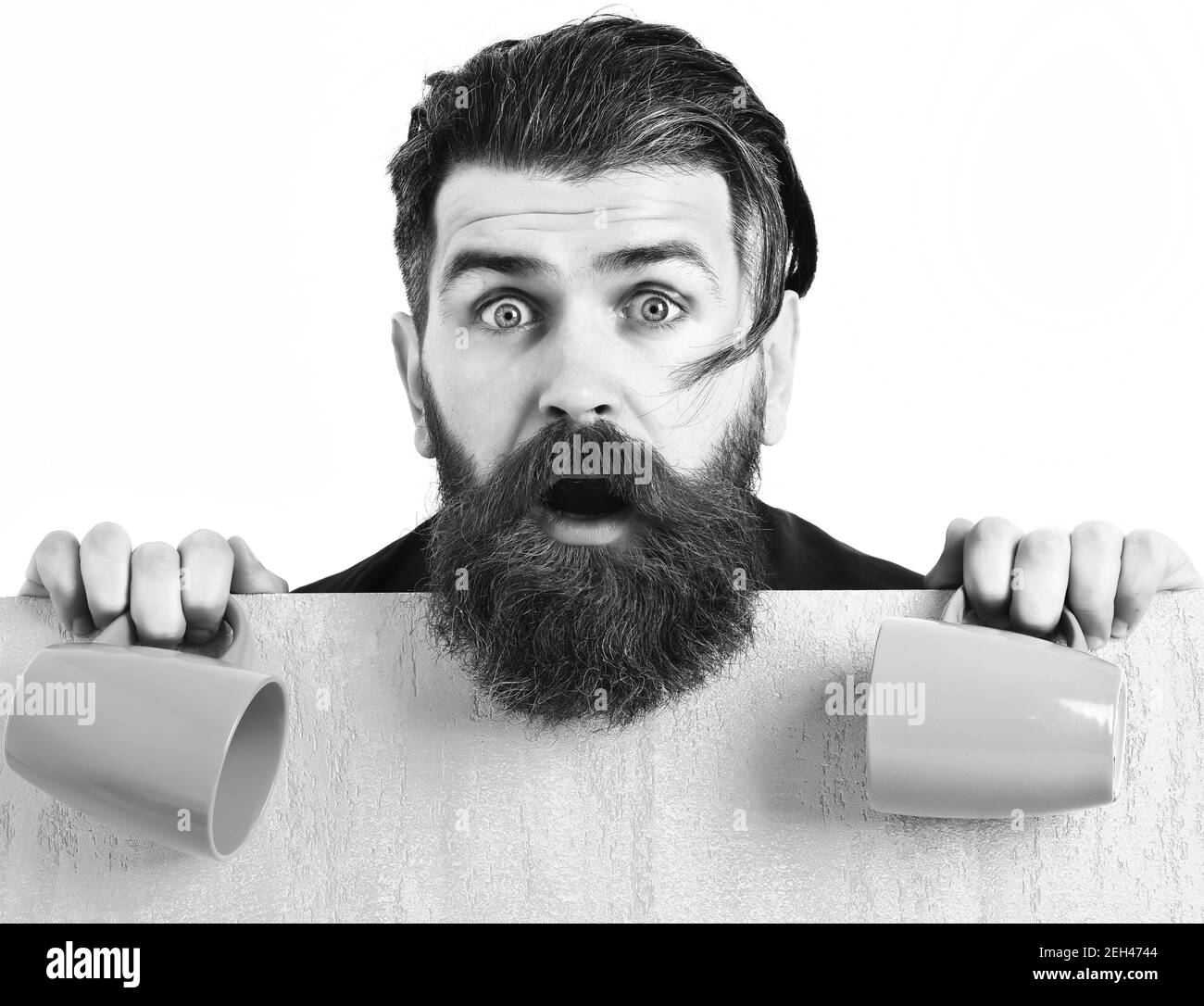 paper sheet holding colorful cups in studio background. Bearded man ... paper sheet holding colorful cups in studio background. Bearded man ...
