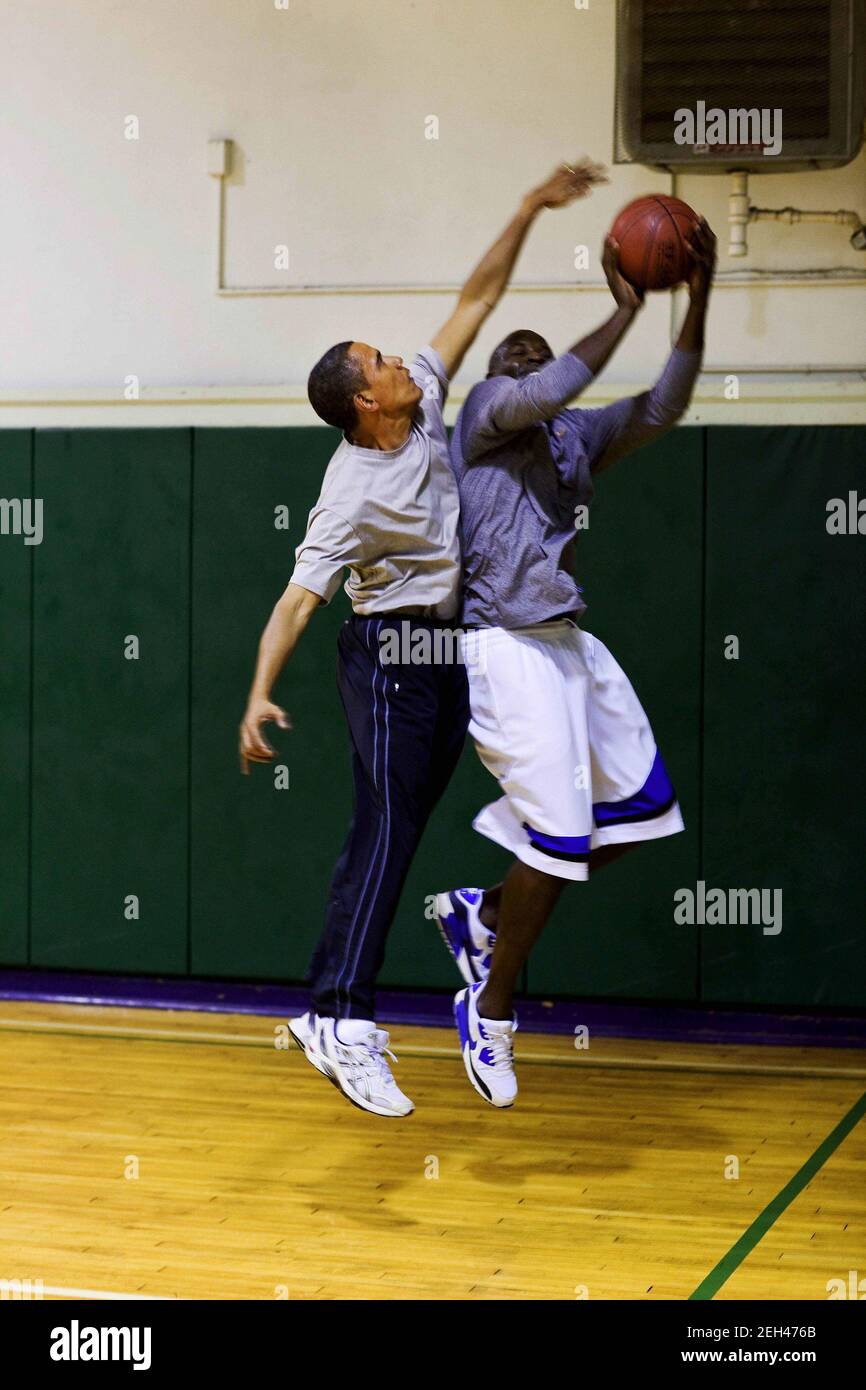 President Barack Obama blocks a shot while playing basketball with ...