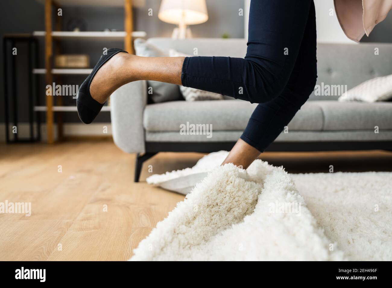 Falldown Hazard. Clumsy Woman Stumbled On Rug Stock Photo - Alamy
