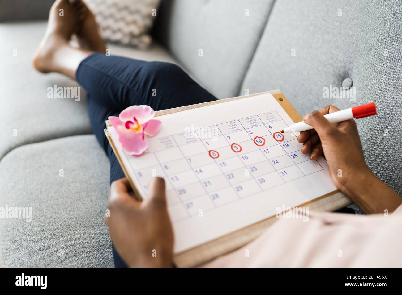 African Woman Using Menstrual Cycle Or Period Calendar Stock Photo - Alamy