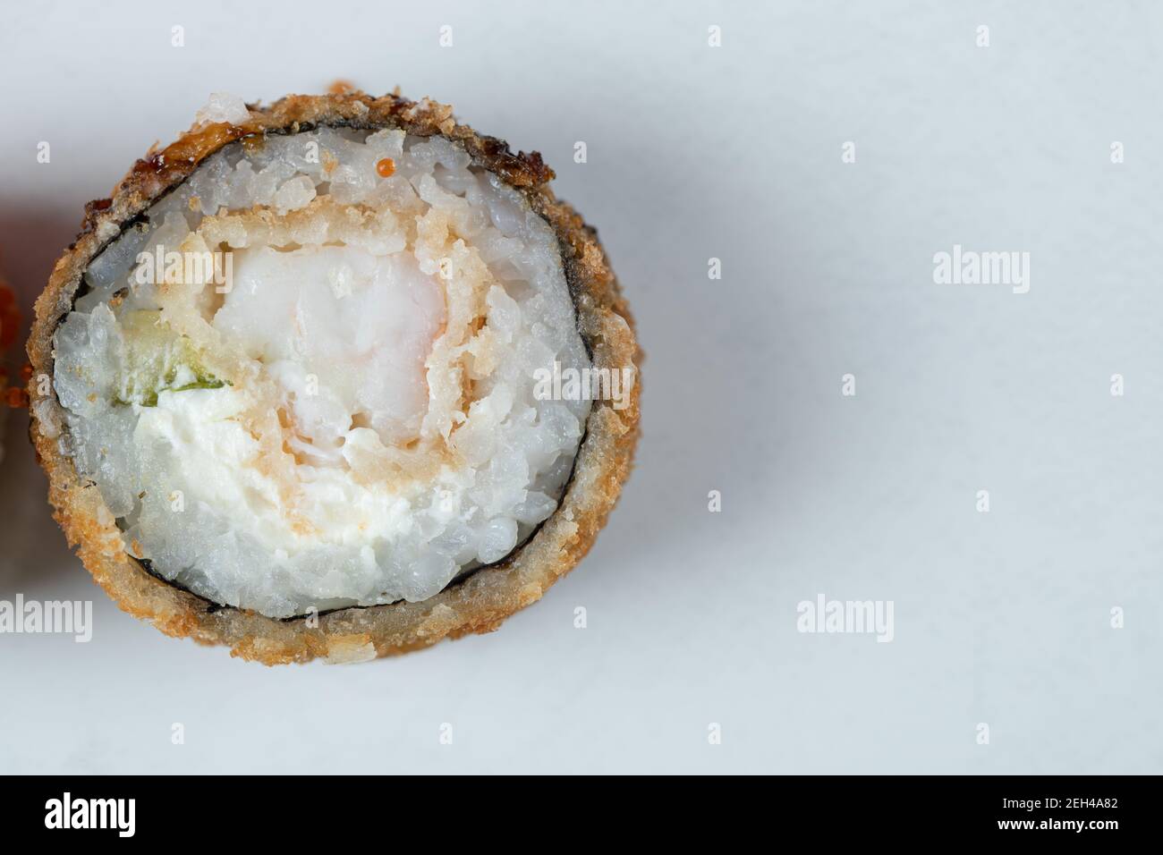Single hot fried sushi roll on a white background Stock Photo - Alamy