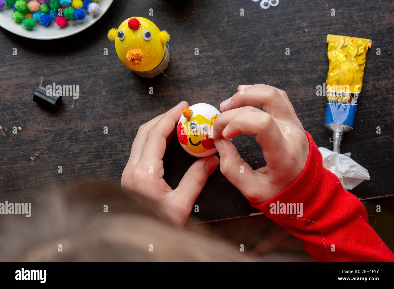 Girl making figurines from eggs, top view Stock Photo - Alamy