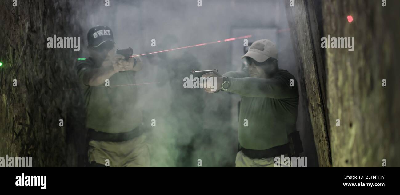 Army soldier in action aiming at weapon laser sight optics. Shooting ...