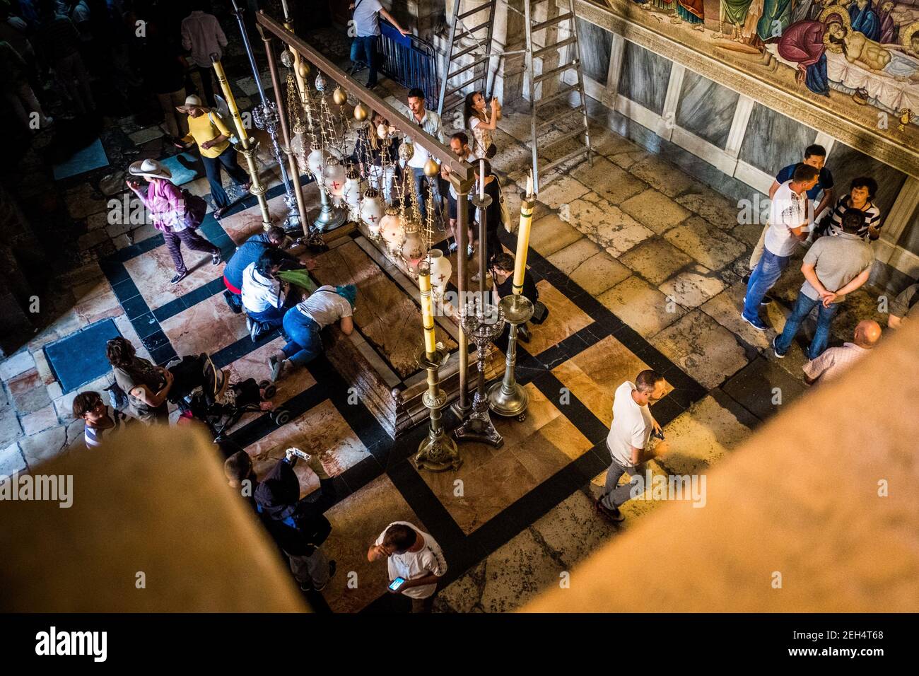 Pilgrims prostrate themselves on the Stone of the Anointing at the ...