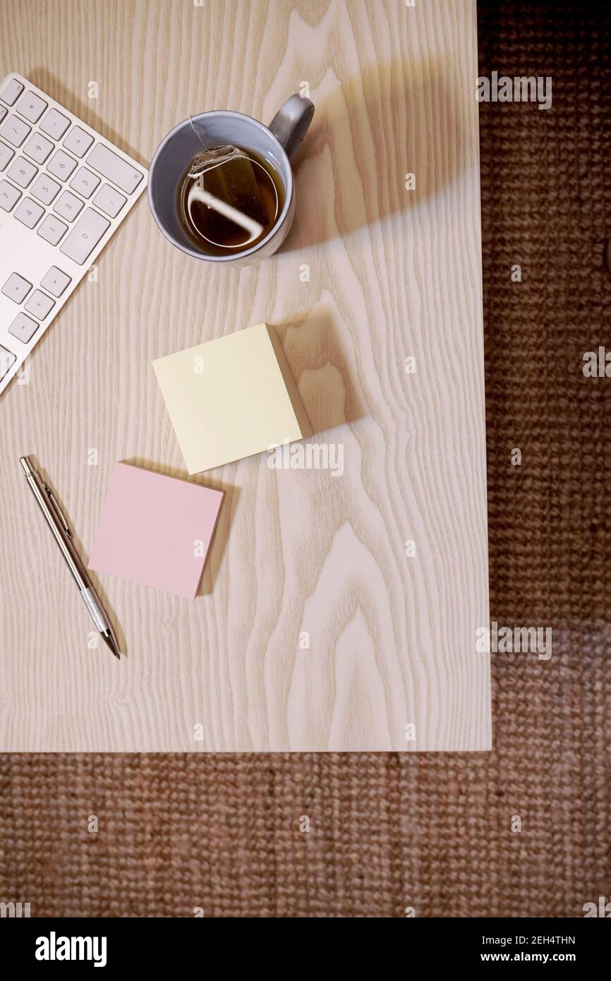 flat lay desk with keyboard block notes and tea Stock Photo - Alamy