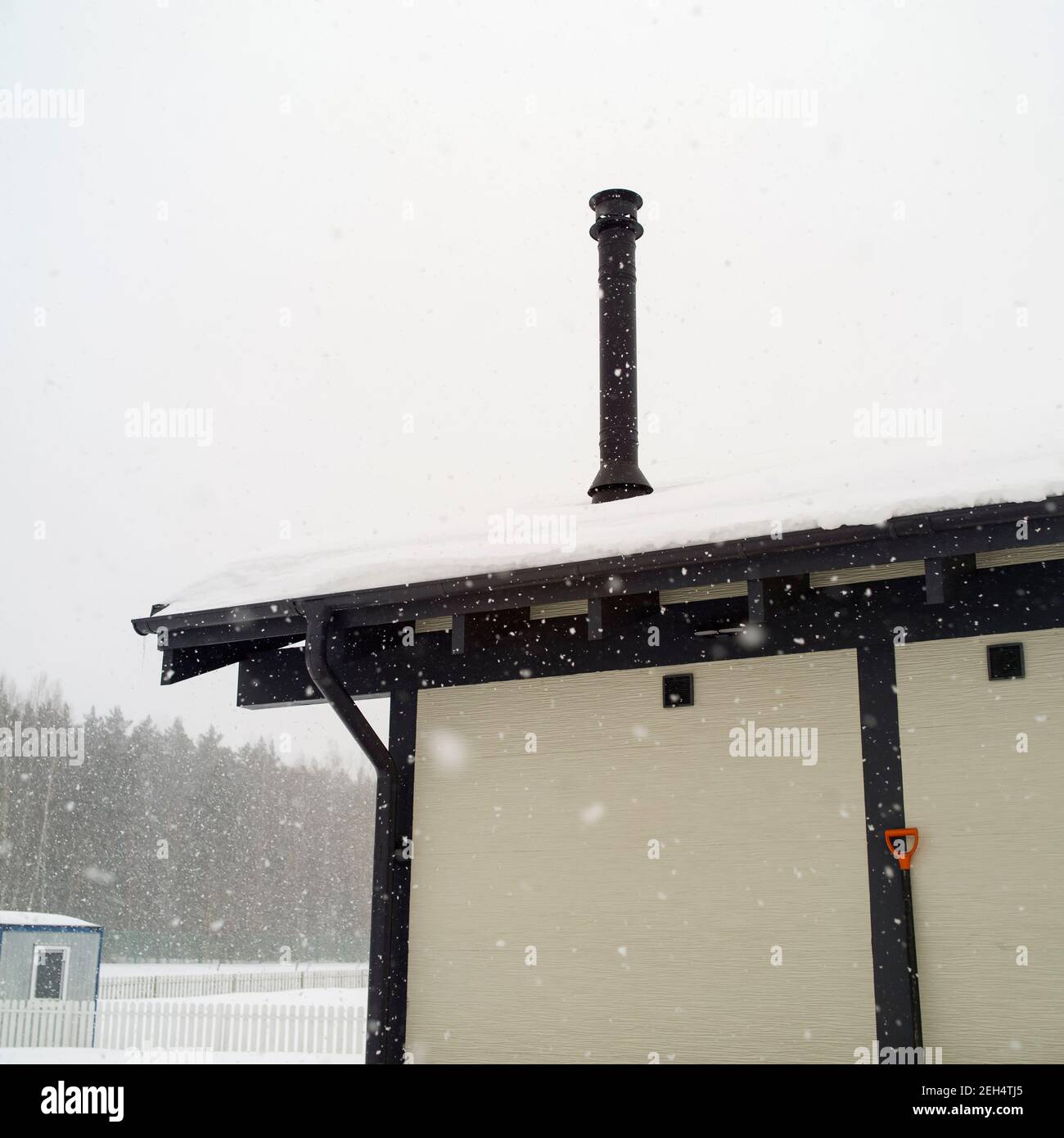A chimney on a rooftop during a massive snowfall, winter scene Stock ...