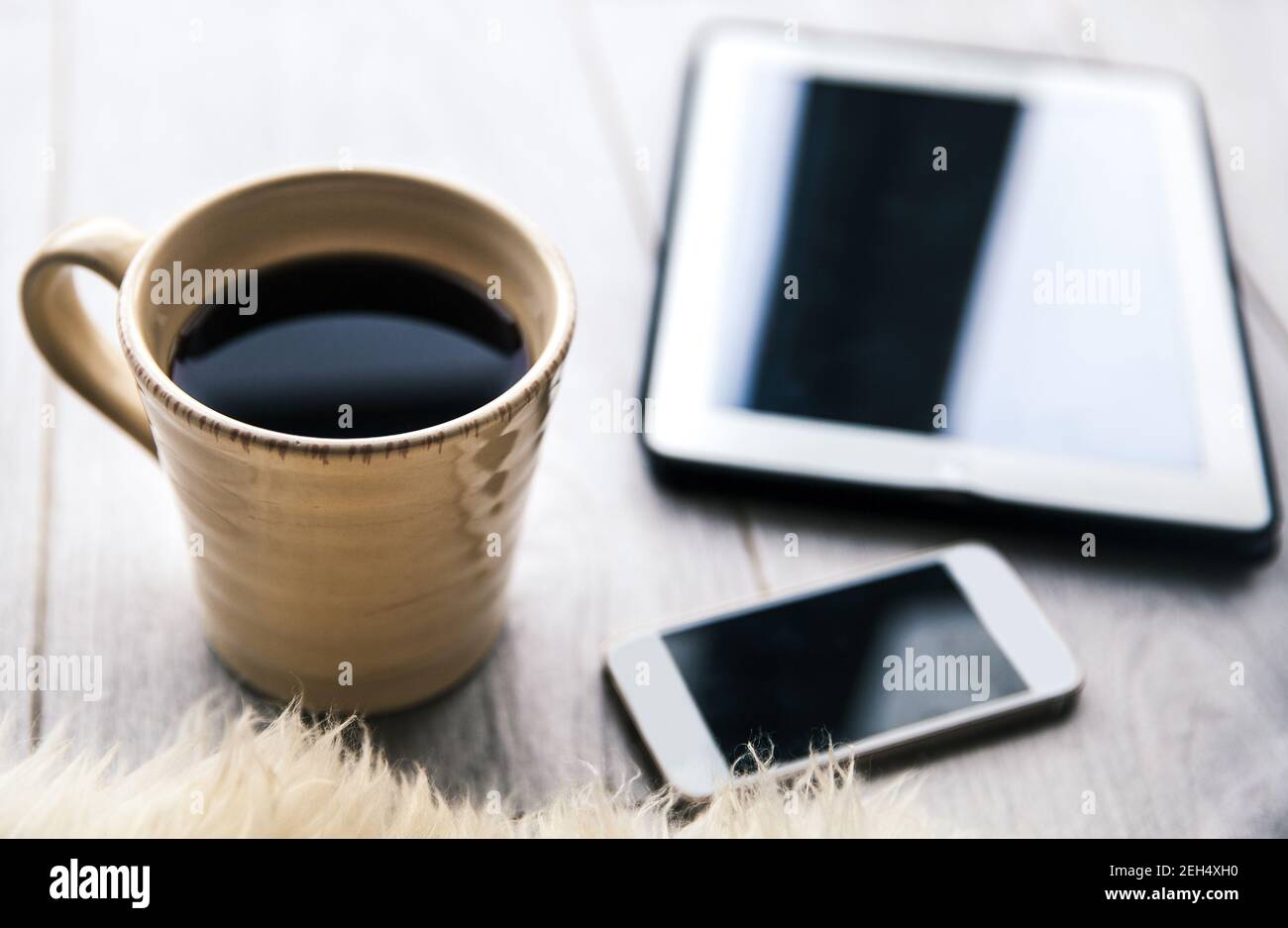 Modern workplace with digital tablet computer and mobile phone, cup of ...