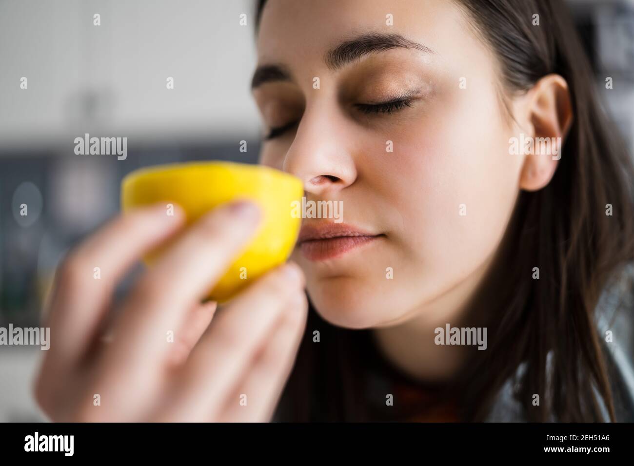 Woman Nose Sniffing Lemon Smell. Coronavirus Symptom Stock Photo - Alamy