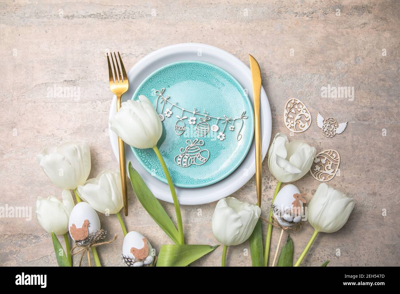 Easter table setting with floral decor on grey table. Elegance dinner ...