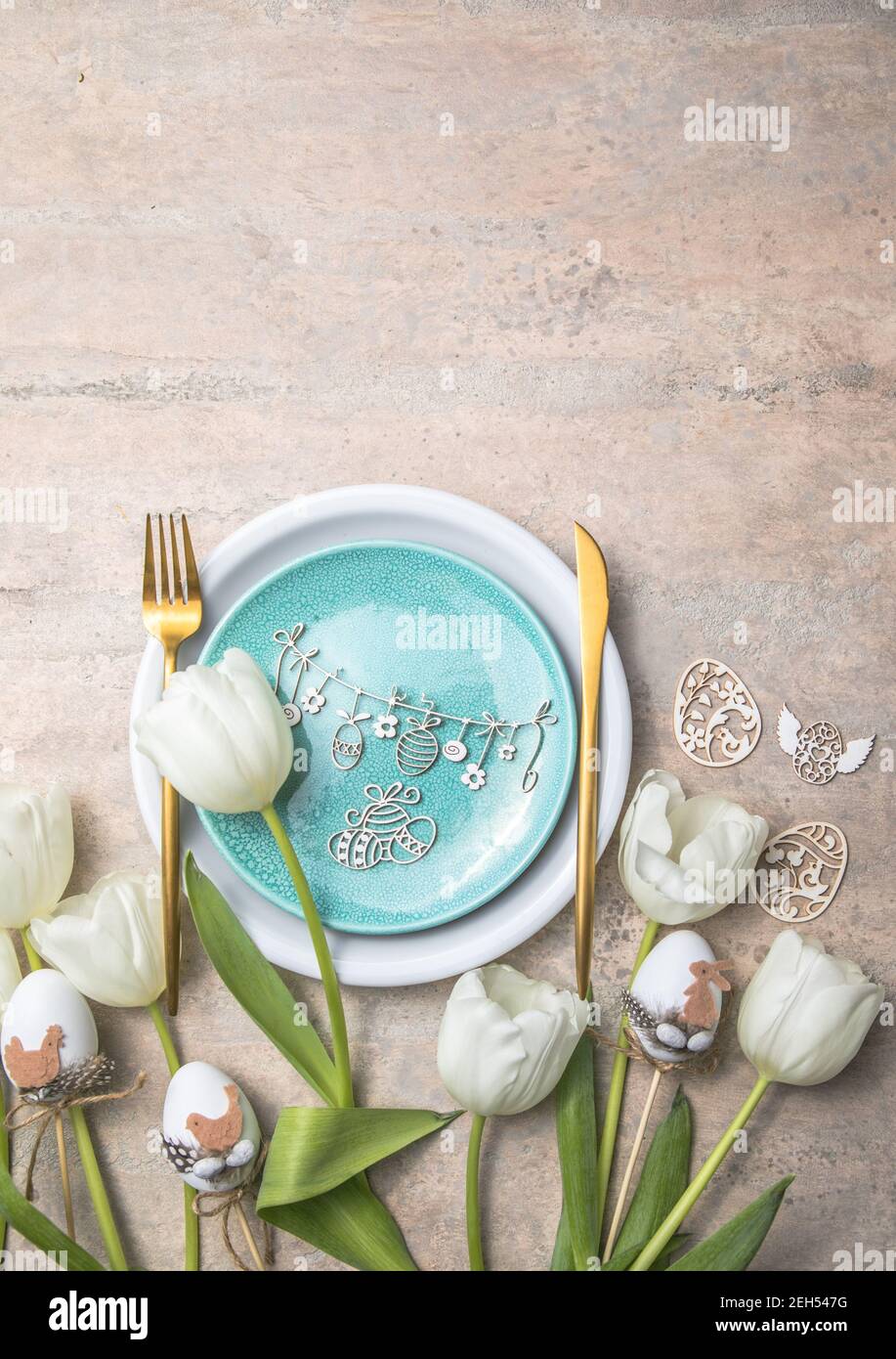 Easter table setting with floral decor on grey table. Elegance dinner ...