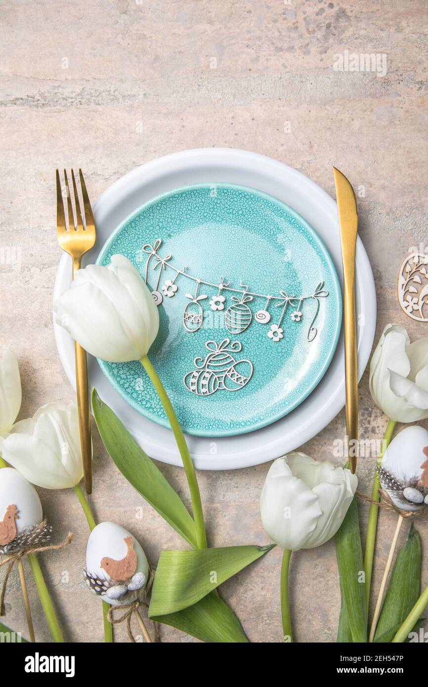 Easter table setting with floral decor on grey table. Elegance dinner ...