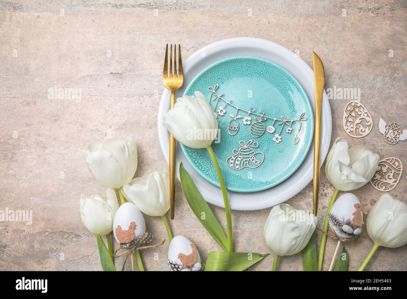Easter table setting with floral decor on grey table. Elegance dinner ...