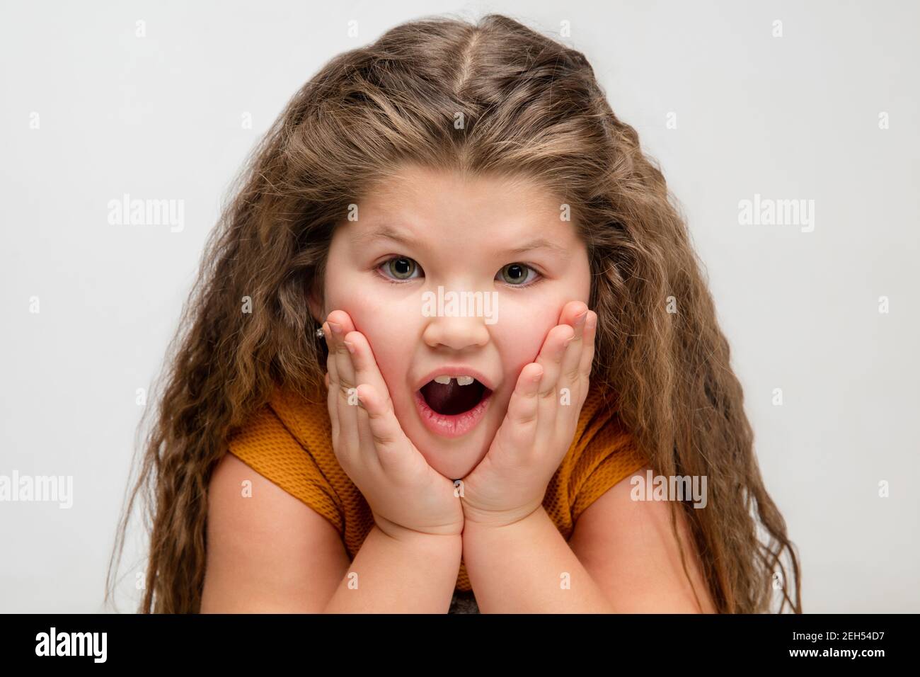Shy, astonished. Happy, smiley little caucasian girl isolated on white ...