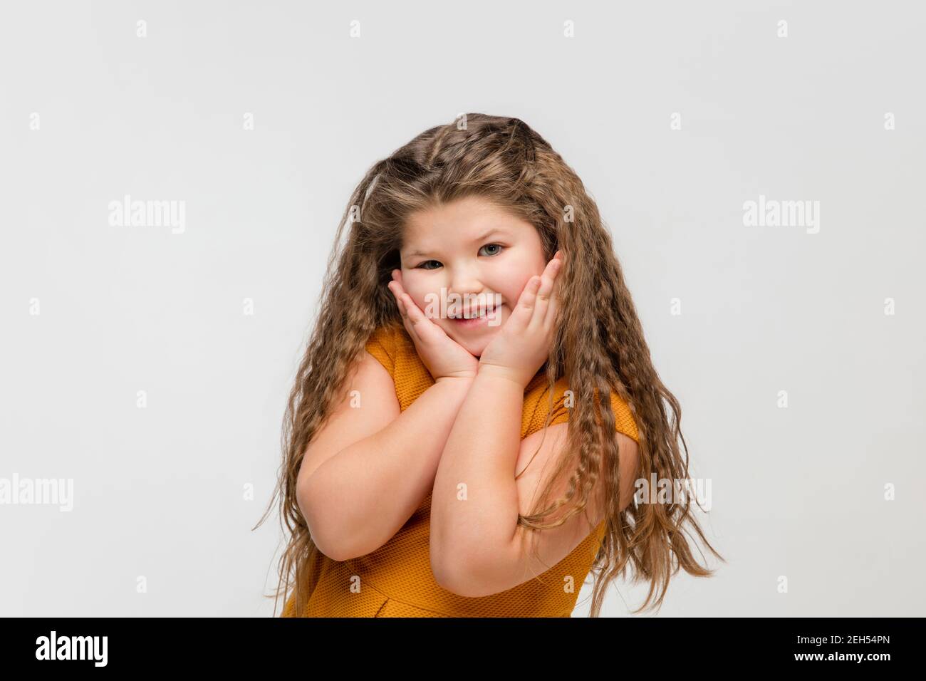 Shy, astonished. Happy, smiley little caucasian girl isolated on white ...