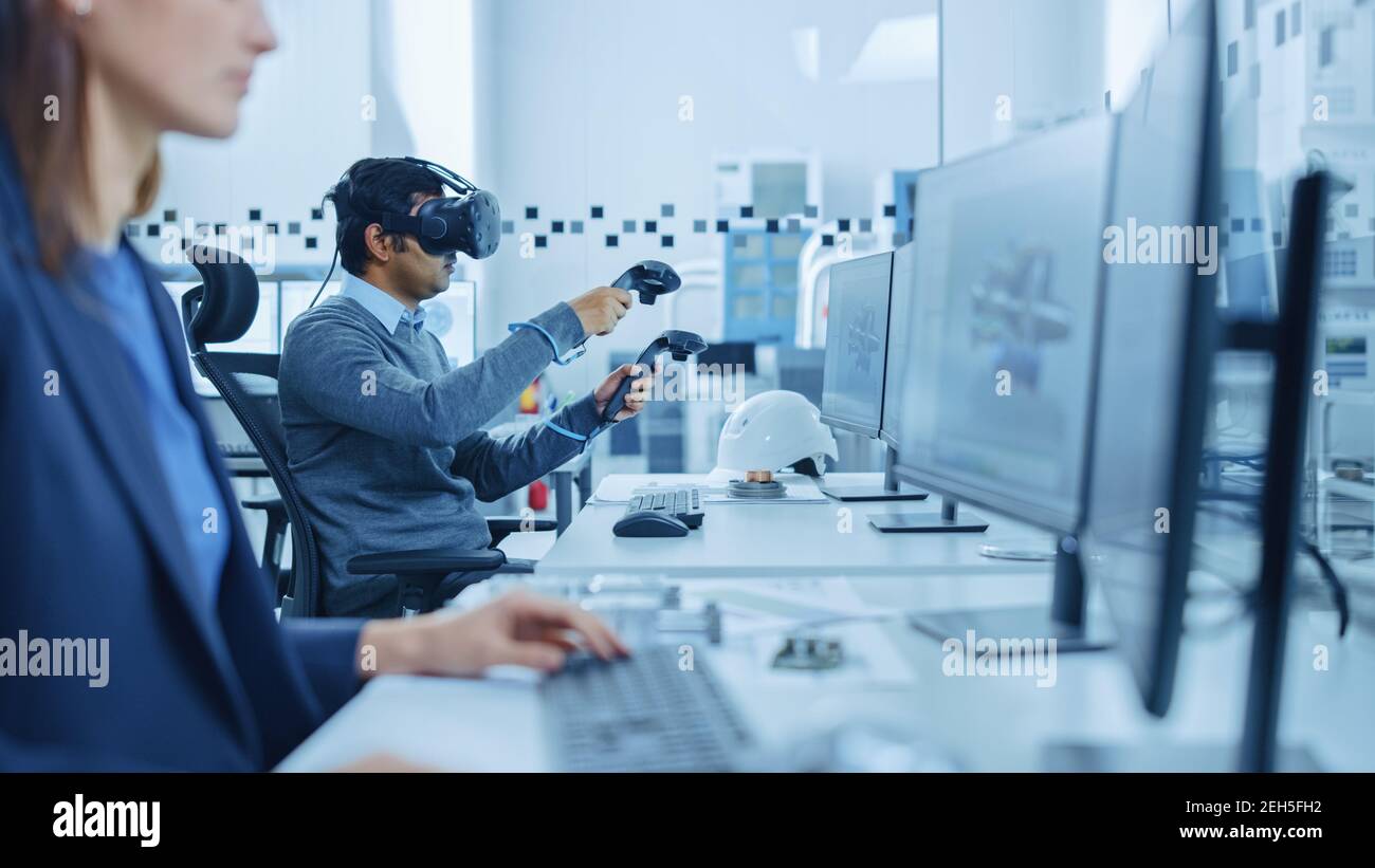 Modern Industrial Factory: Mechanical Engineer Wearing Virtual Reality Headset, Holding ...