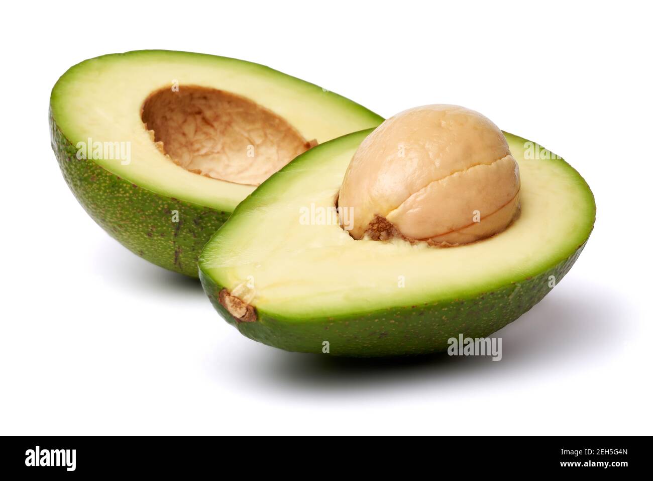 Halved Green avocado with seed isolated on a white background with ...