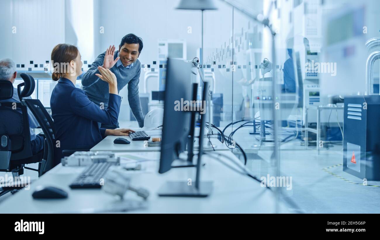 Inside Factory Office: Male Project Supervisor Talks to a Female ...