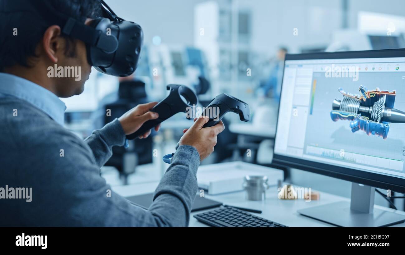 Modern Industrial Factory: Mechanical Engineer Wearing Virtual Reality Headset, Holding ...