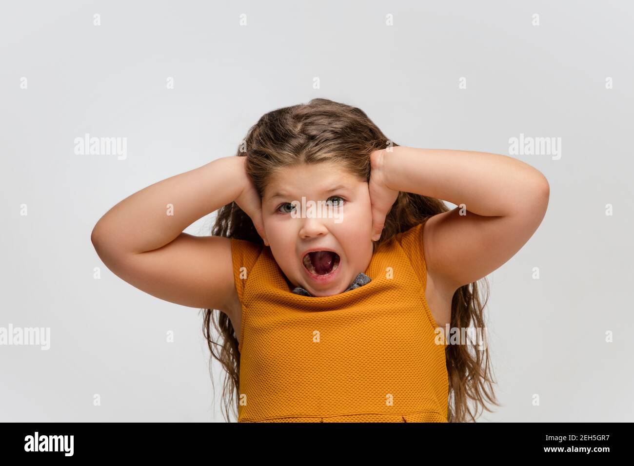 Scared. Happy, smiley little caucasian girl isolated on white studio ...