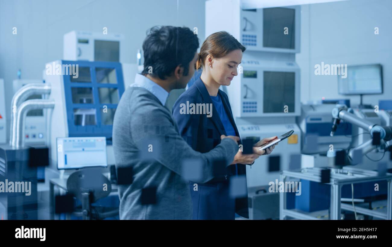 Modern Factory: Female Project Manager and Male Engineer Walk Through ...