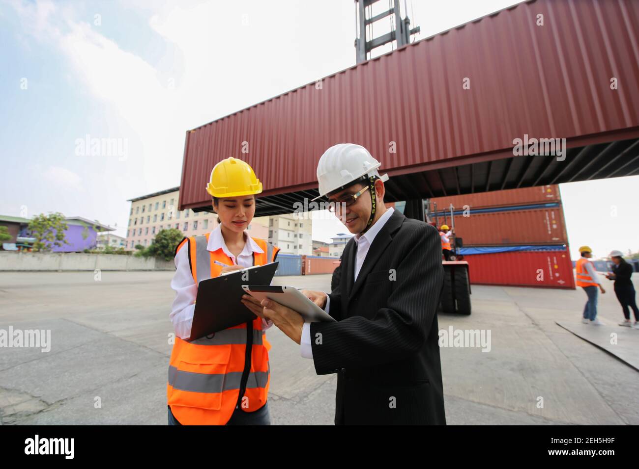 Engineer or supervisor checking and control loading Containers box from ...