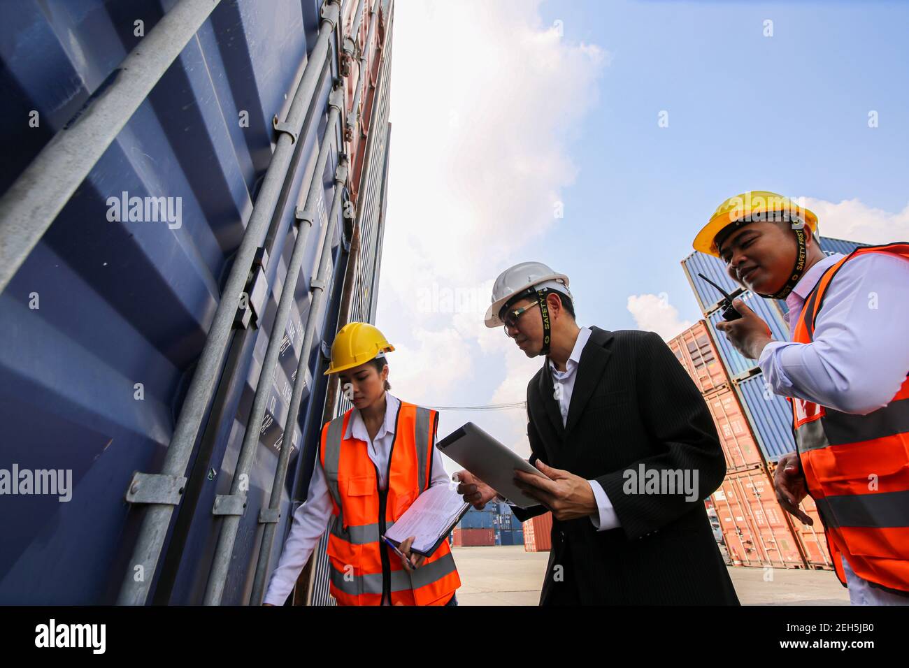 Engineer or supervisor checking and control loading Containers box from ...