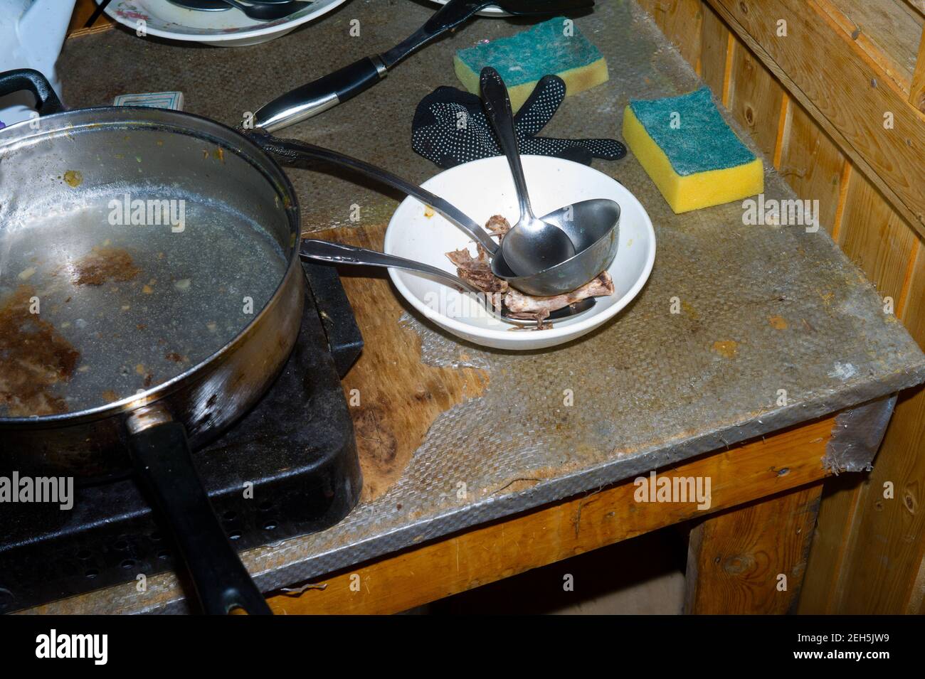 Messy kitchen table and leftovers in a plate, indoor closeup Stock ...