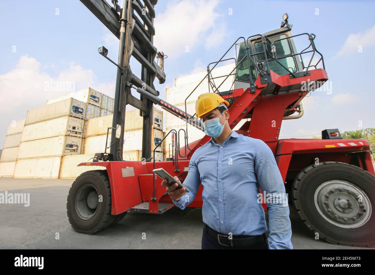 Engineer or supervisor checking and control loading Containers box from ...