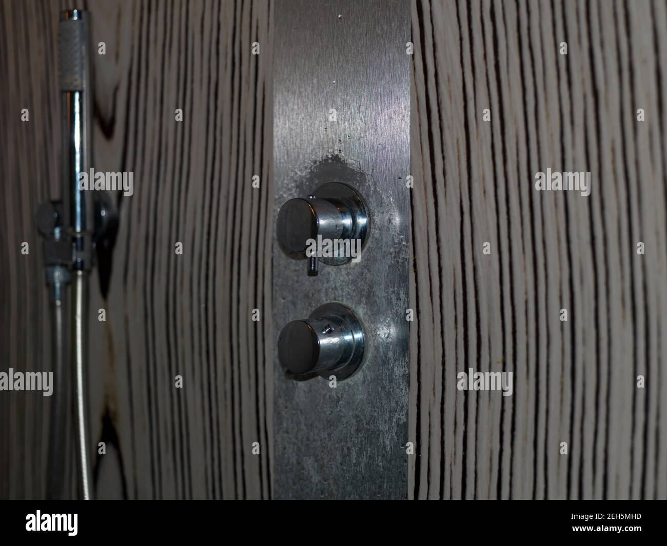 A shower steel panel covered with corrosion, indoor closeup, shallow ...