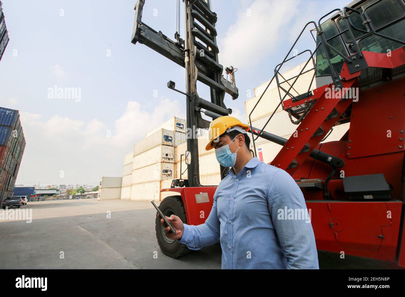 Engineer or supervisor checking and control loading Containers box from ...