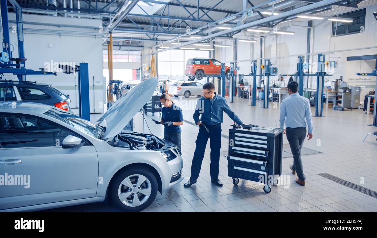 Two automotive mechanics inspecting vehicle hi-res stock photography ...
