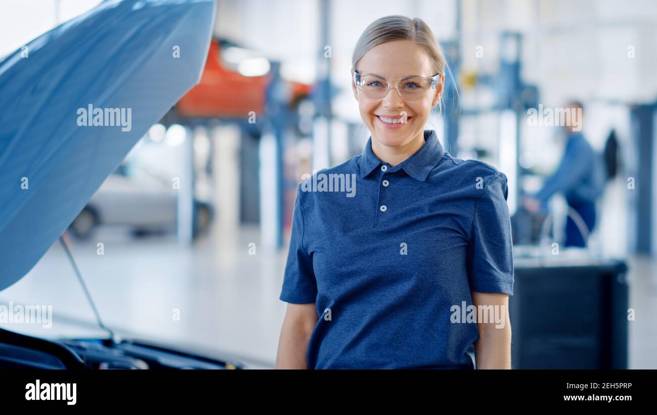 Beautiful Empowering Female Car Mechanic is in a Vehicle Service. She ...