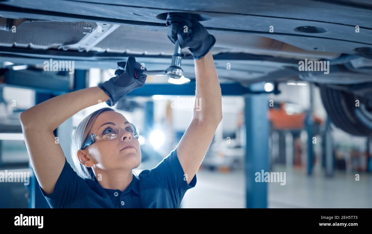 Woman mechanic working underneath hi-res stock photography and images ...